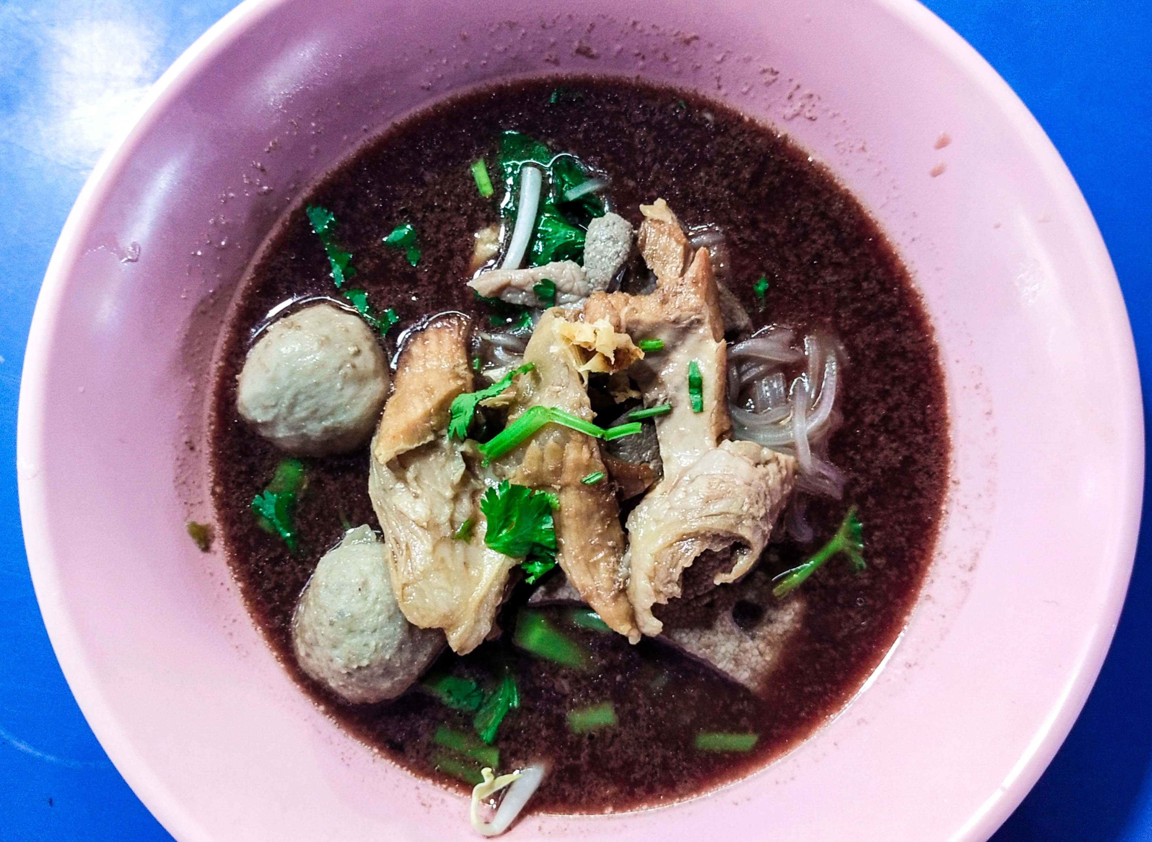 Nai Rung Guay Tiew Nam Tok Moo Yentafo Tom Yum delivery near you in ...